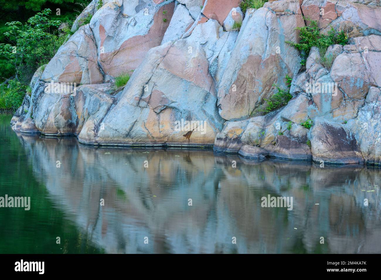 Pink granite reflected in George Lake, Killarney Provincial Park ...