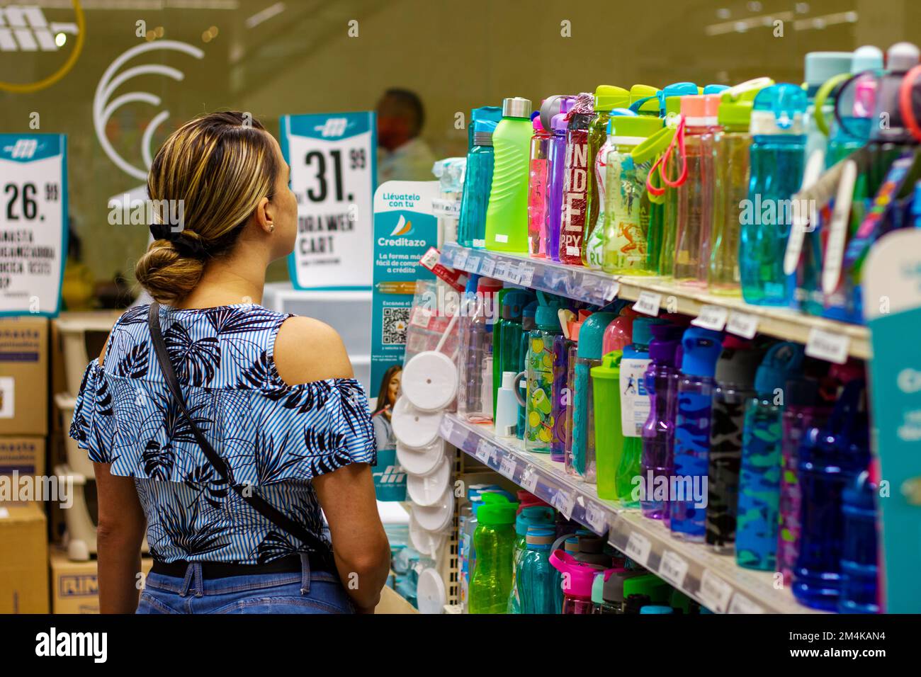 girl looking at various kinds of knobs on store shelf Stock Photo - Alamy