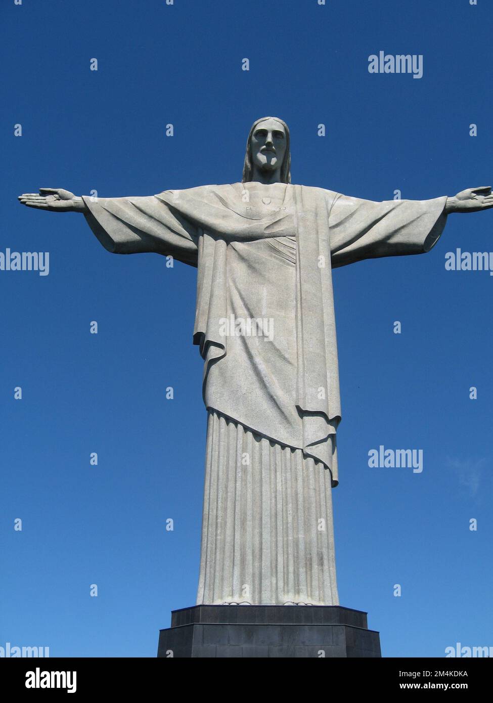 A vertical shot of the famous Christ the Redeemer statue in Rio against ...