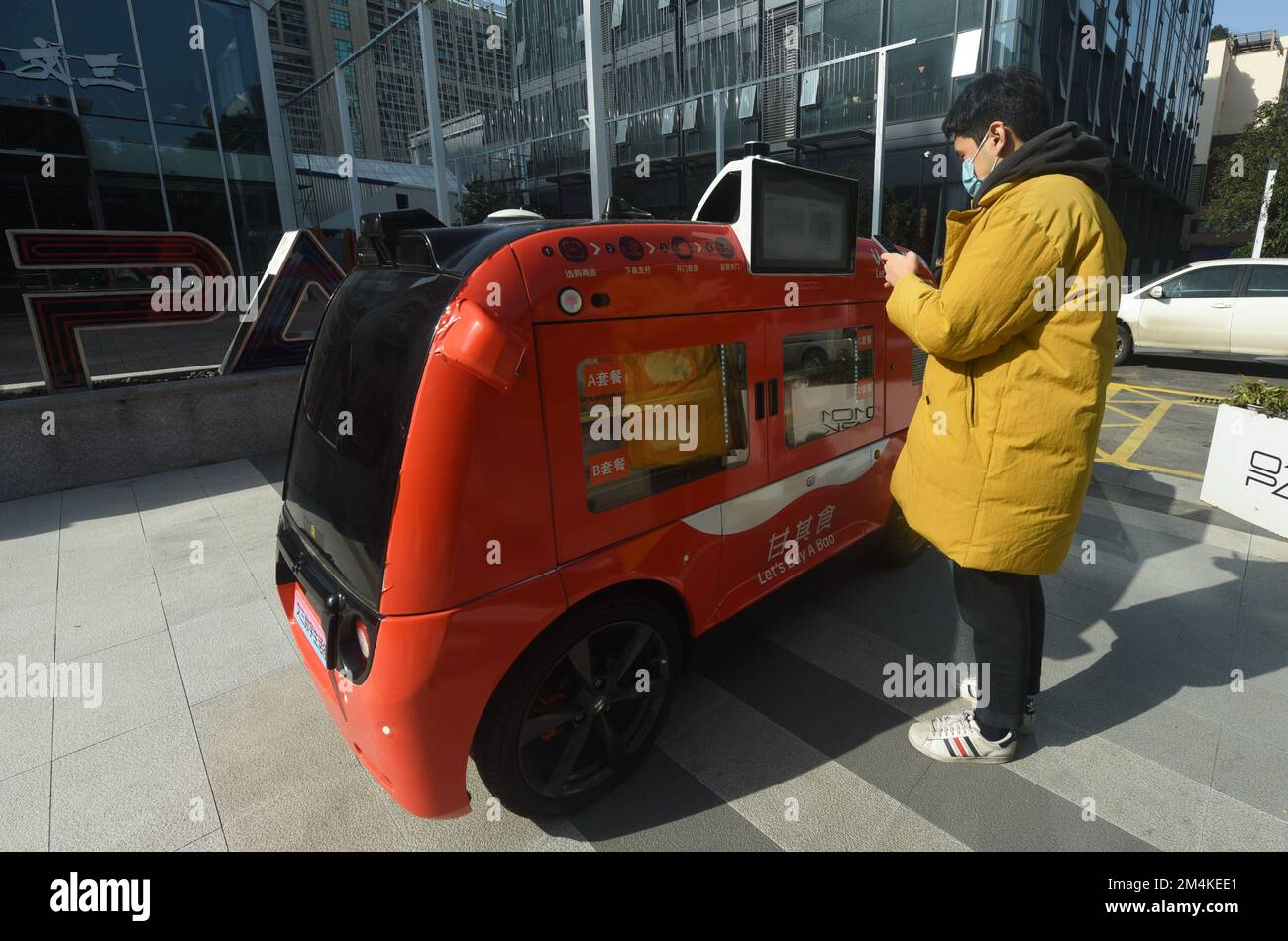 HANGZHOU, CHINA - DECEMBER 22, 2022 - Citizens walk past an unmanned ...