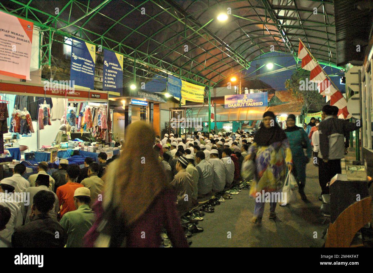 People walking on a walking space behind Daarut Tauhid congregation ...