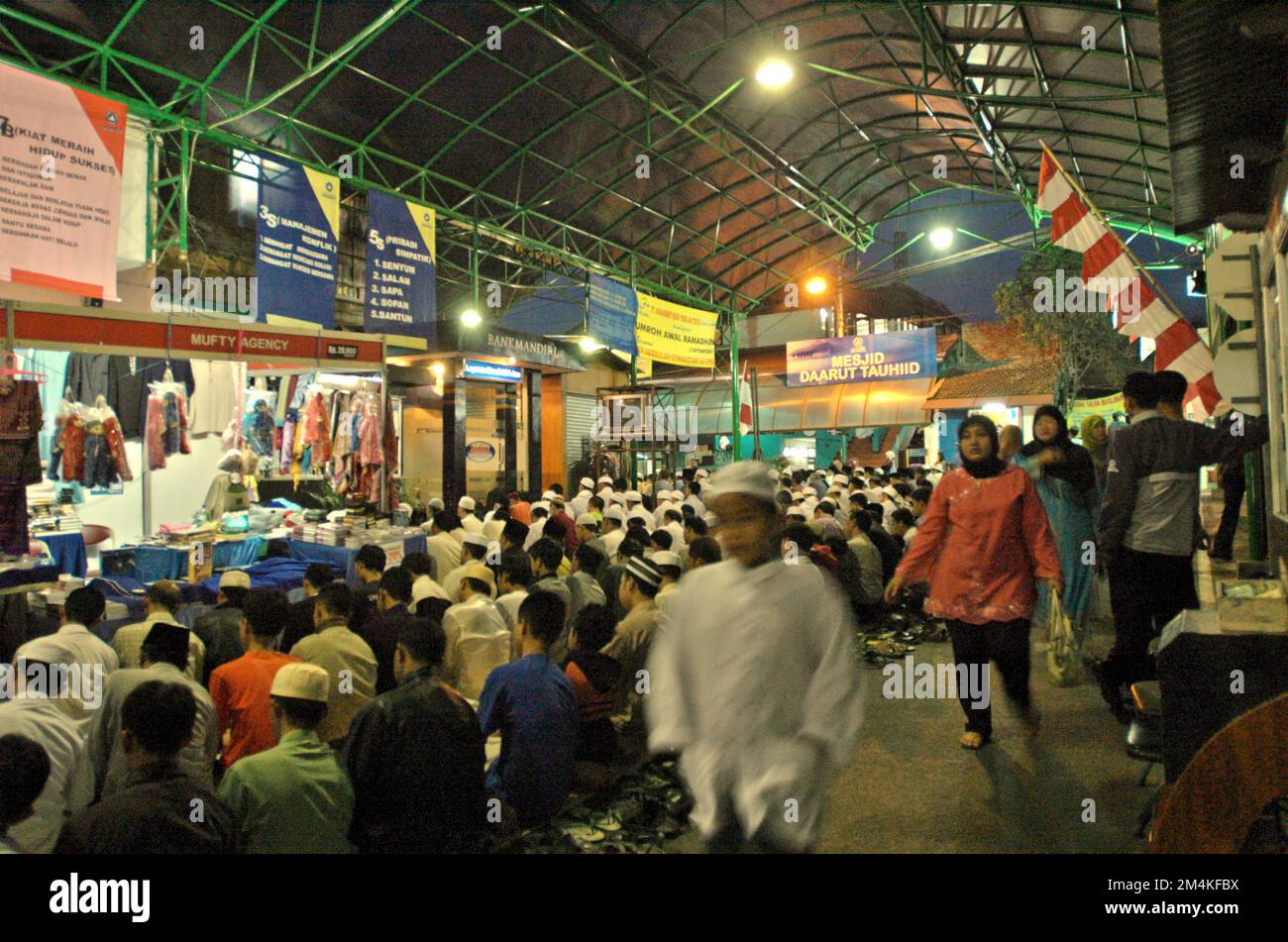 People walking on a walking space behind Daarut Tauhid congregation ...