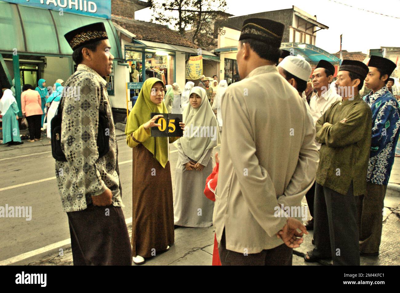 A woman guide is explaining the day's program to a group of religious ...