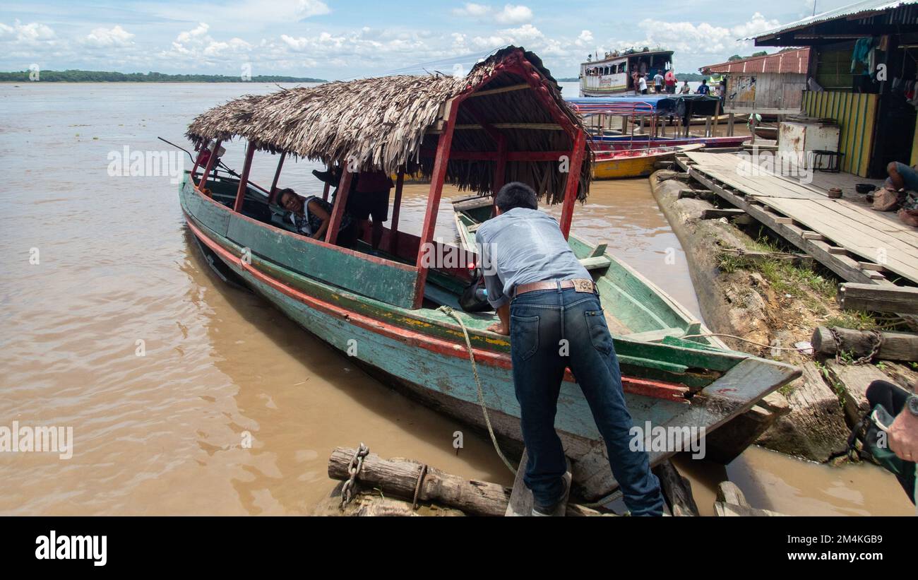 The man pushing a boat to sea Stock Photo - Alamy