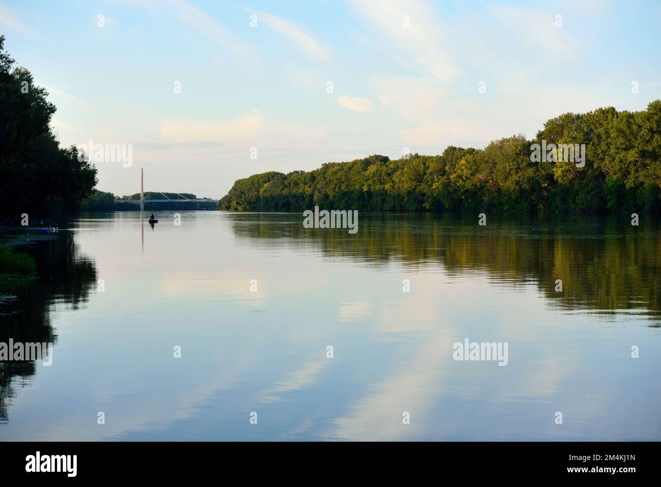 A beautiful natural view of a river with a reflection of a blue sky and ...