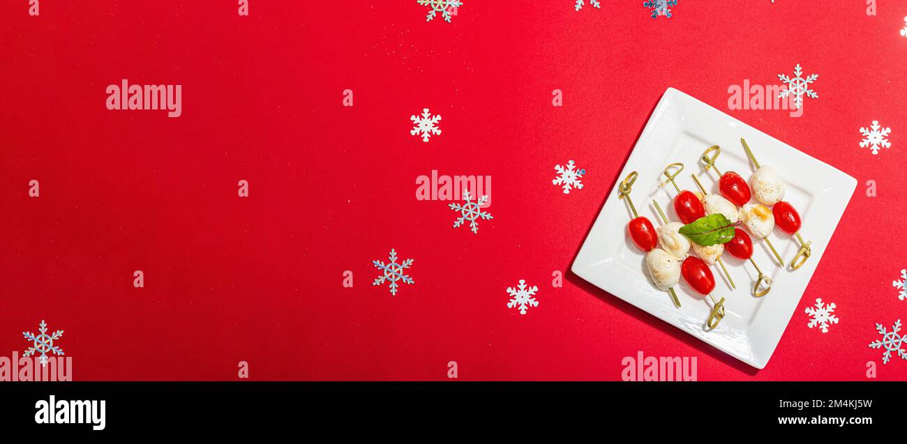 Traditional Italian appetizer in Christmas style. Mozzarella, and ...