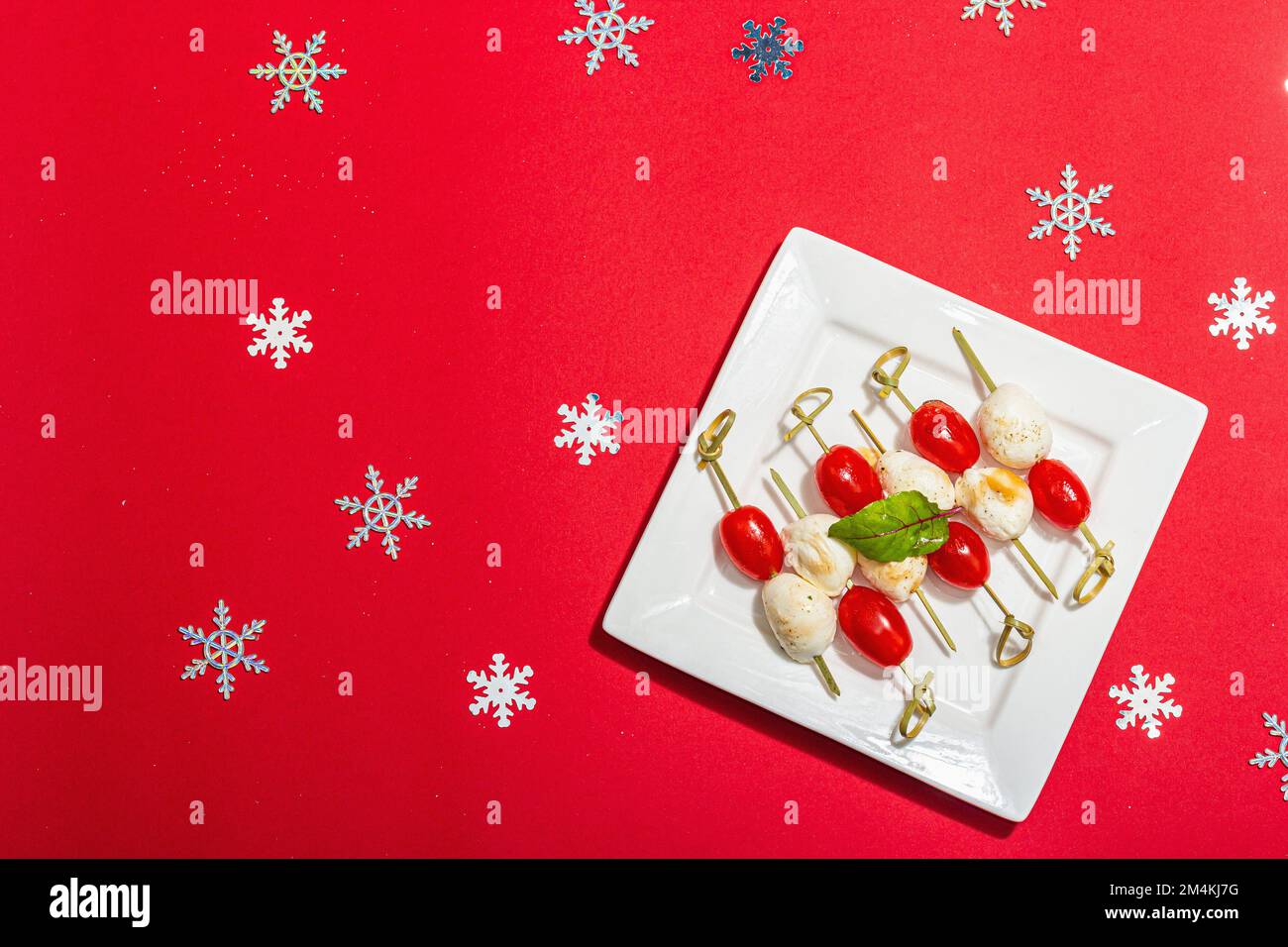 Traditional Italian appetizer in Christmas style. Mozzarella, and ...