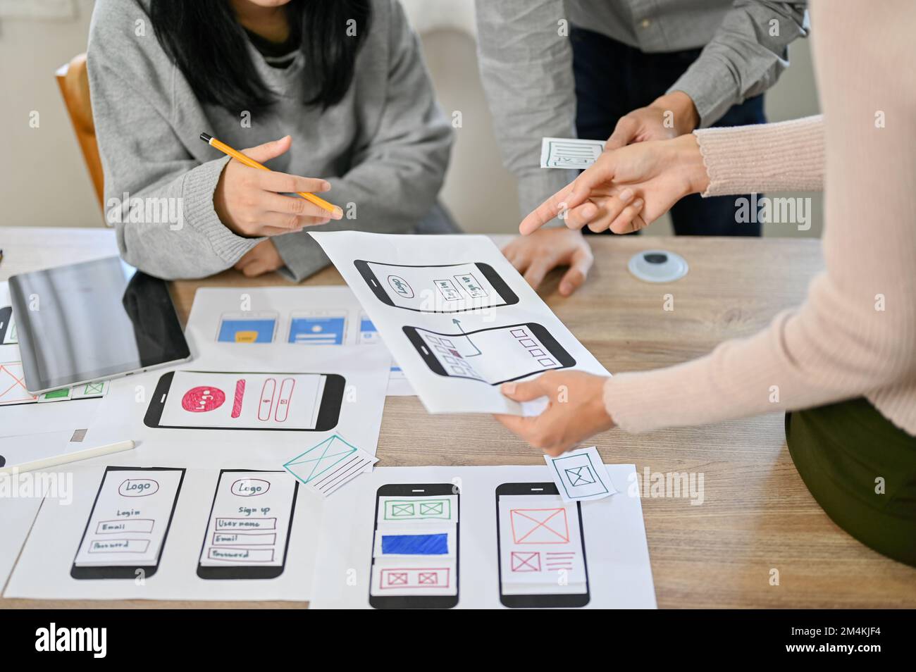 Team of professional mobile application developers checking and testing ... Team of professional mobile application developers checking and testing ...