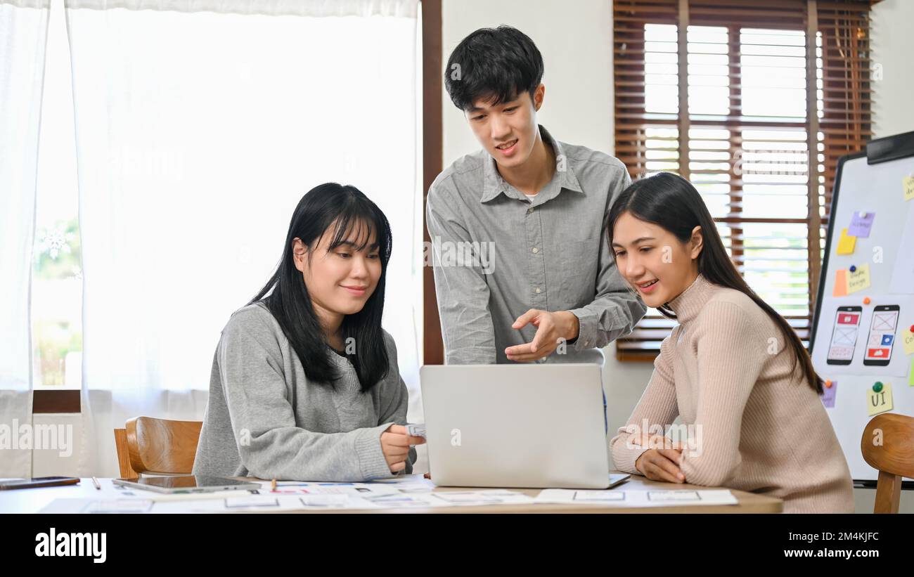 Group of millennial Asian website and mobile application developers ...