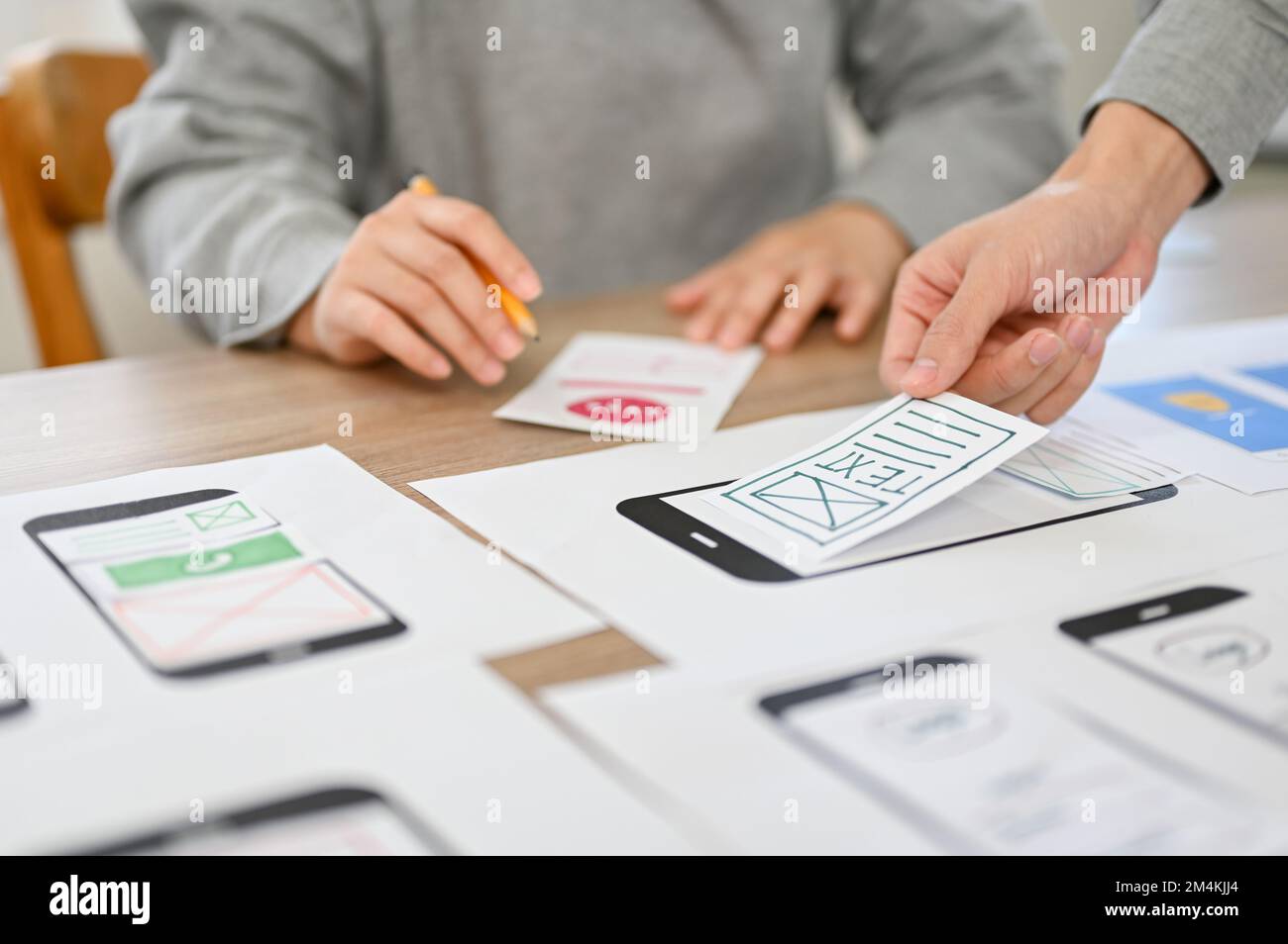 A Team Of Mobile Application Interface Designers Are In The Meeting
