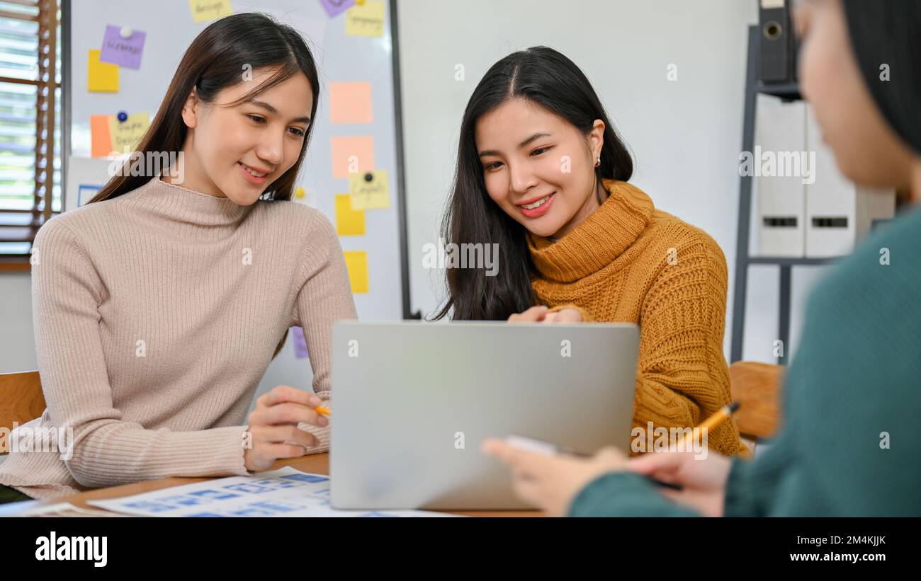 Smart millennials Asian UX developer and UI designer are in the meeting ...