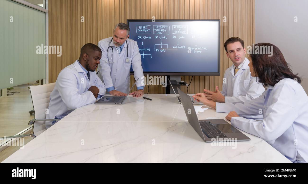 Group of doctors meeting in office with flat screen TV for presentation ...