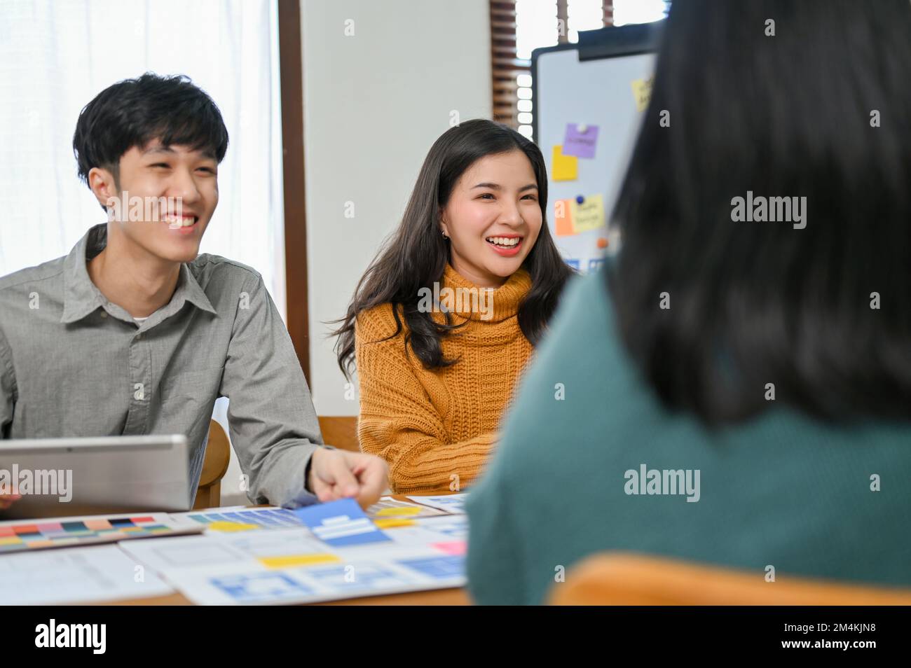 Happy and cheerful millennial Asian business team startup in the ...