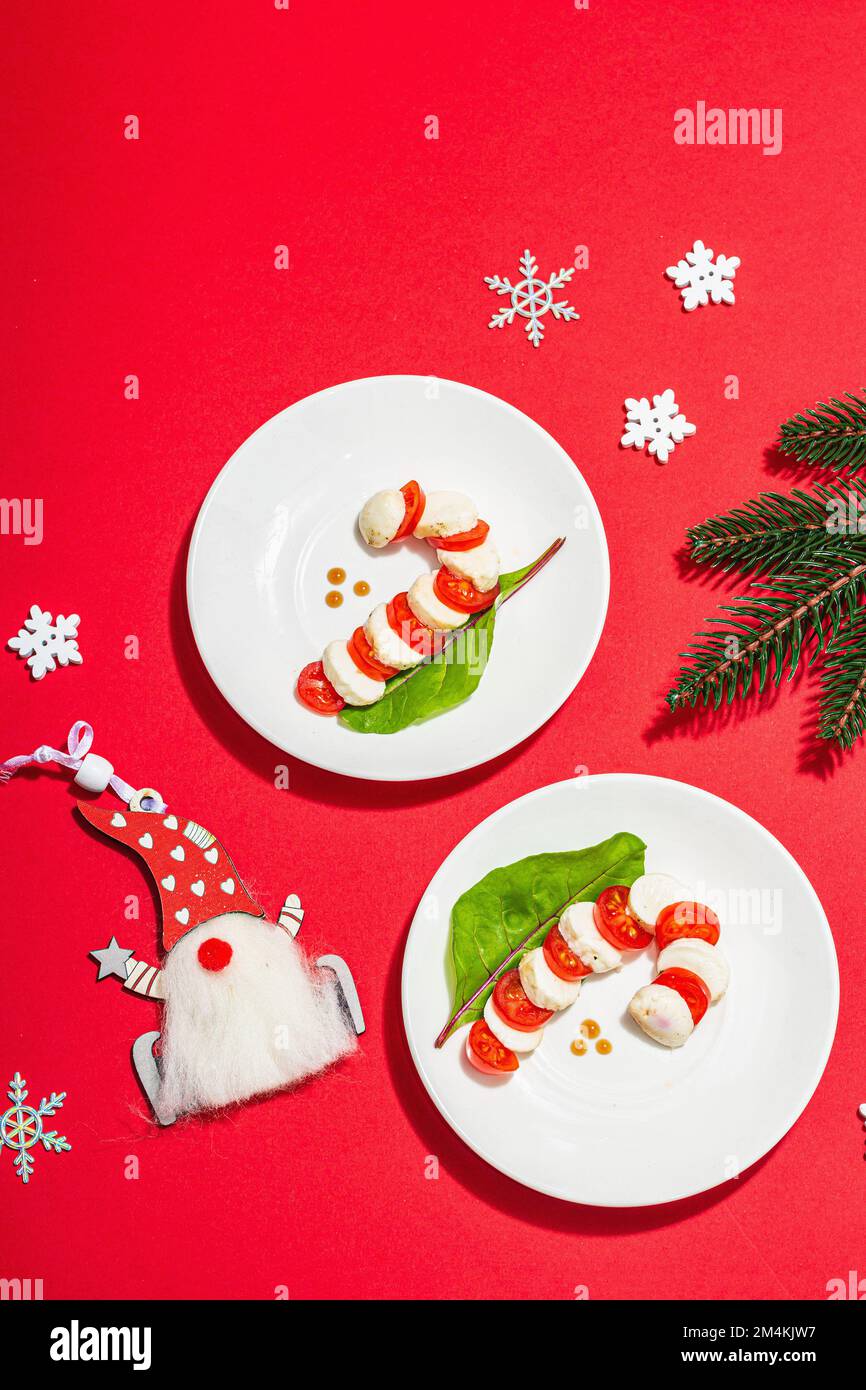 Caprese salad in form of a Christmas candy cane. Traditional New Year ...