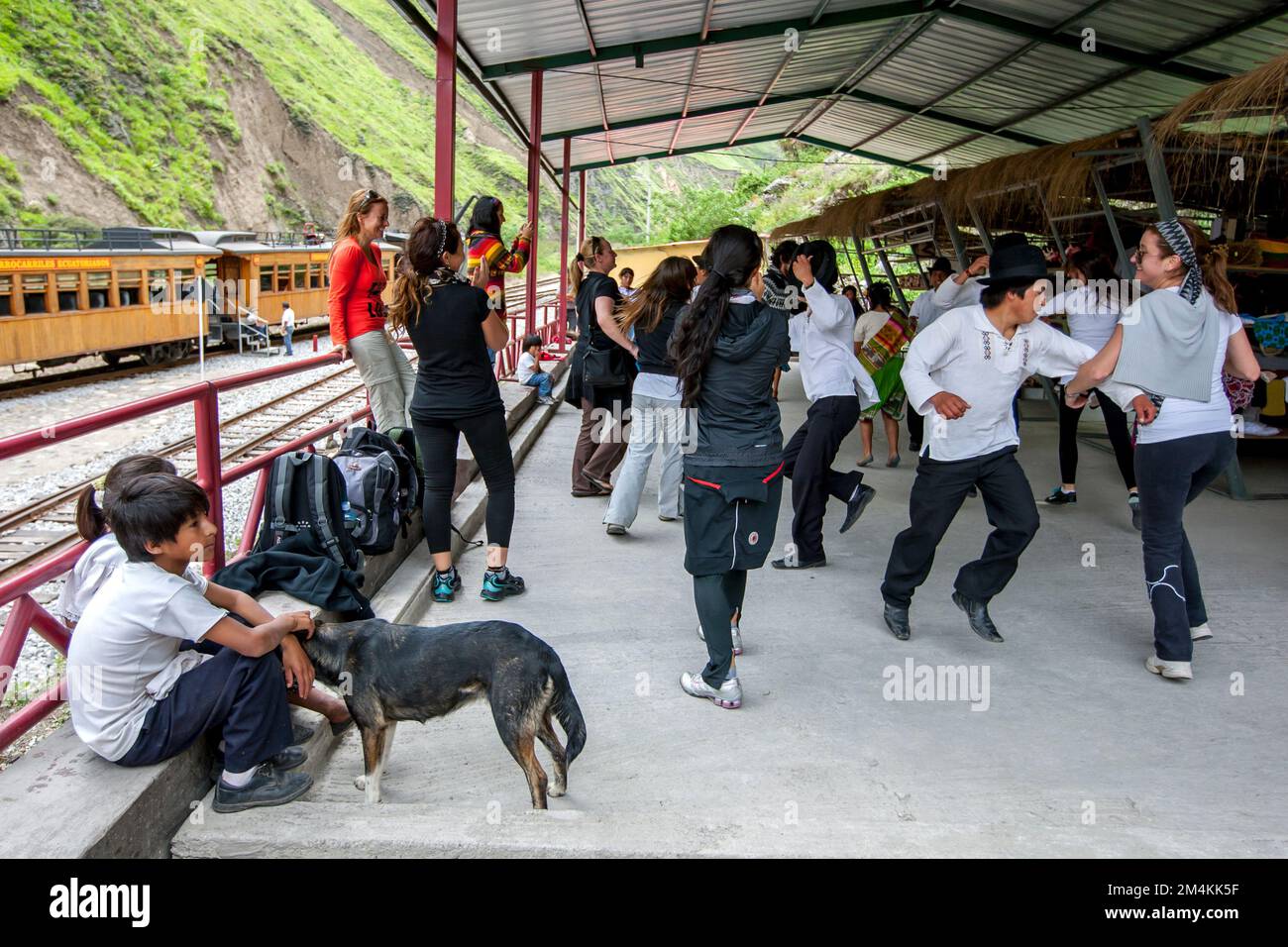 Tourists and Ecuadorian men dance at the Sibambe Station in Ecuador ...