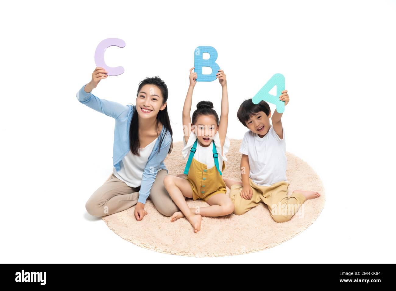 A young female teacher counseling students learning Stock Photo - Alamy