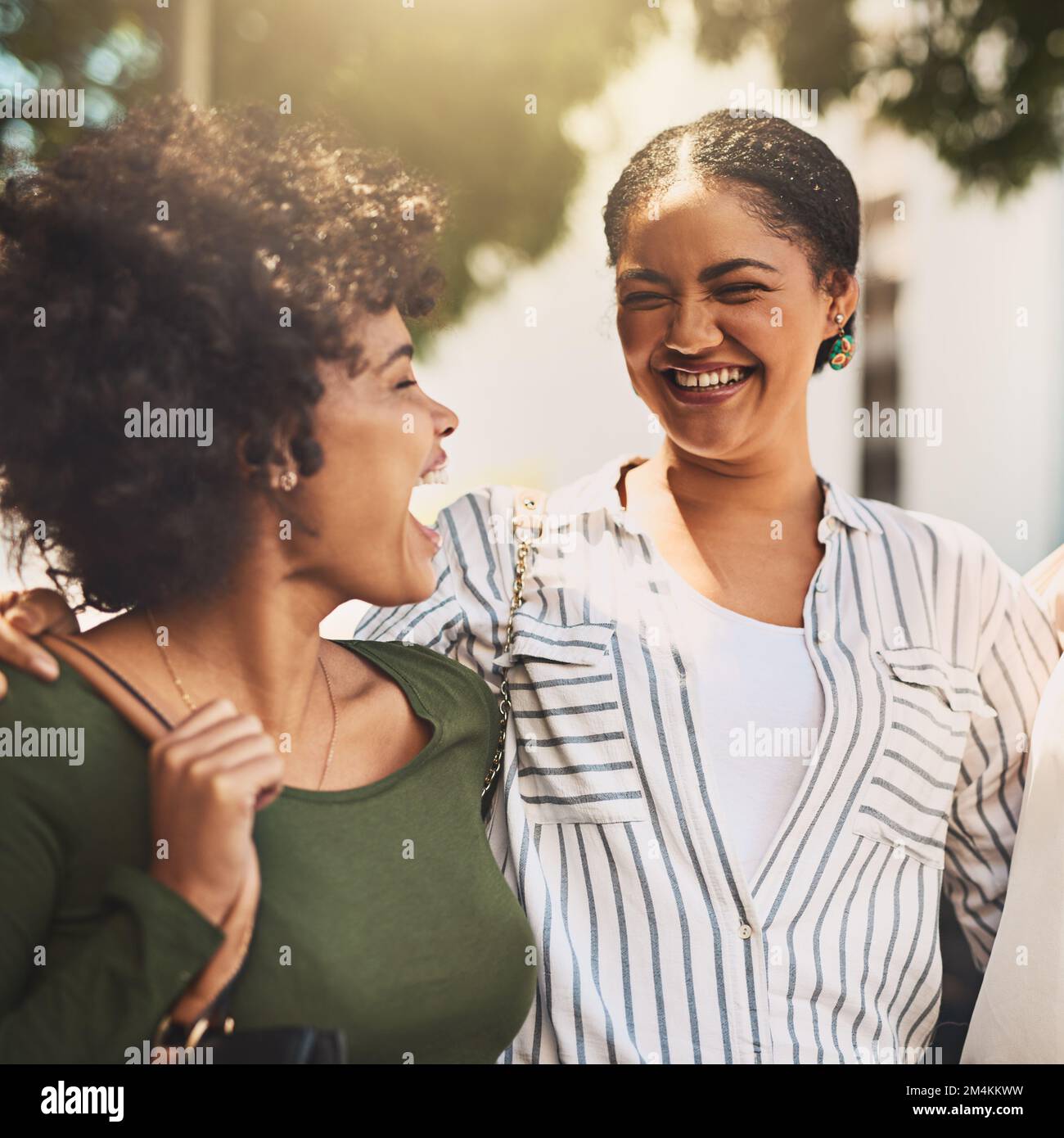 We grew up together. two cheerful young friends standing together while ...