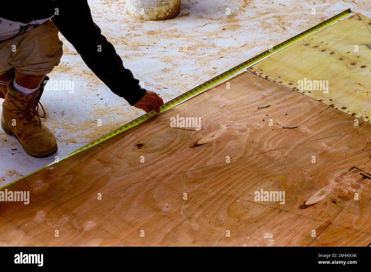 Carpentry work the worker hand with a pencil with measuring length of ...