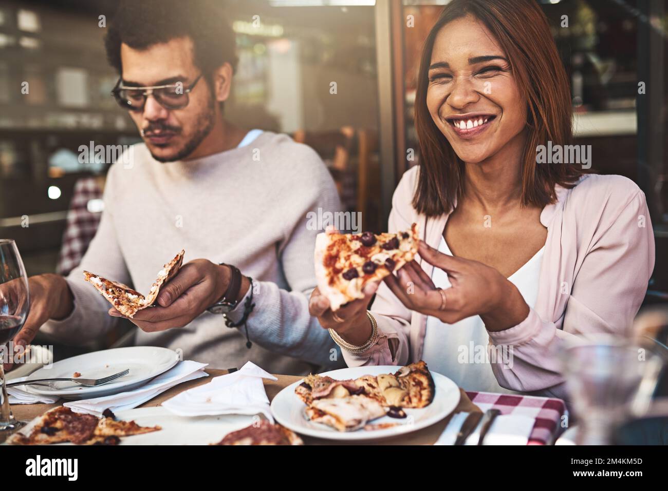 Pizza is the best. a cheerful young woman and man eating pizza together ...