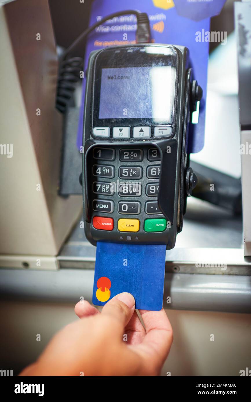 The plastic way to pay. an unrecognizable woman making payment in a ...
