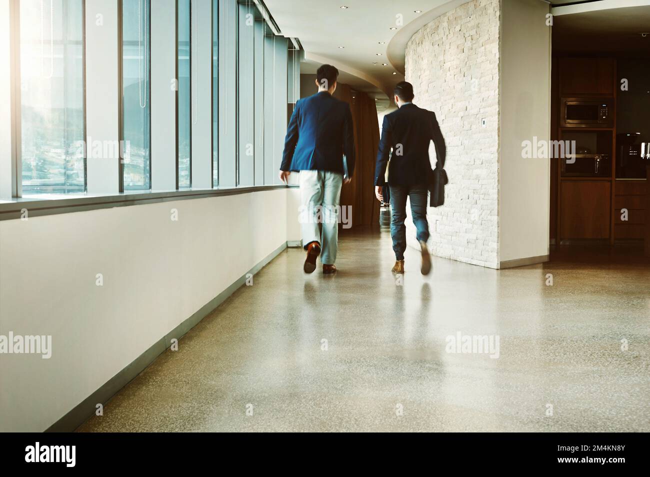 Success begins with one step. Rearview shot of two young businessmen ...