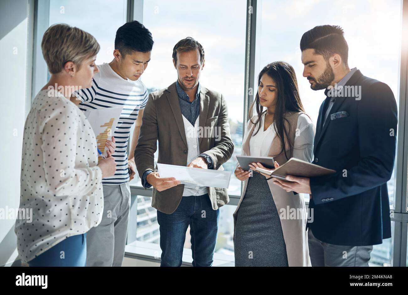 Setting plans in motion. a group of young businesspeople having a ...