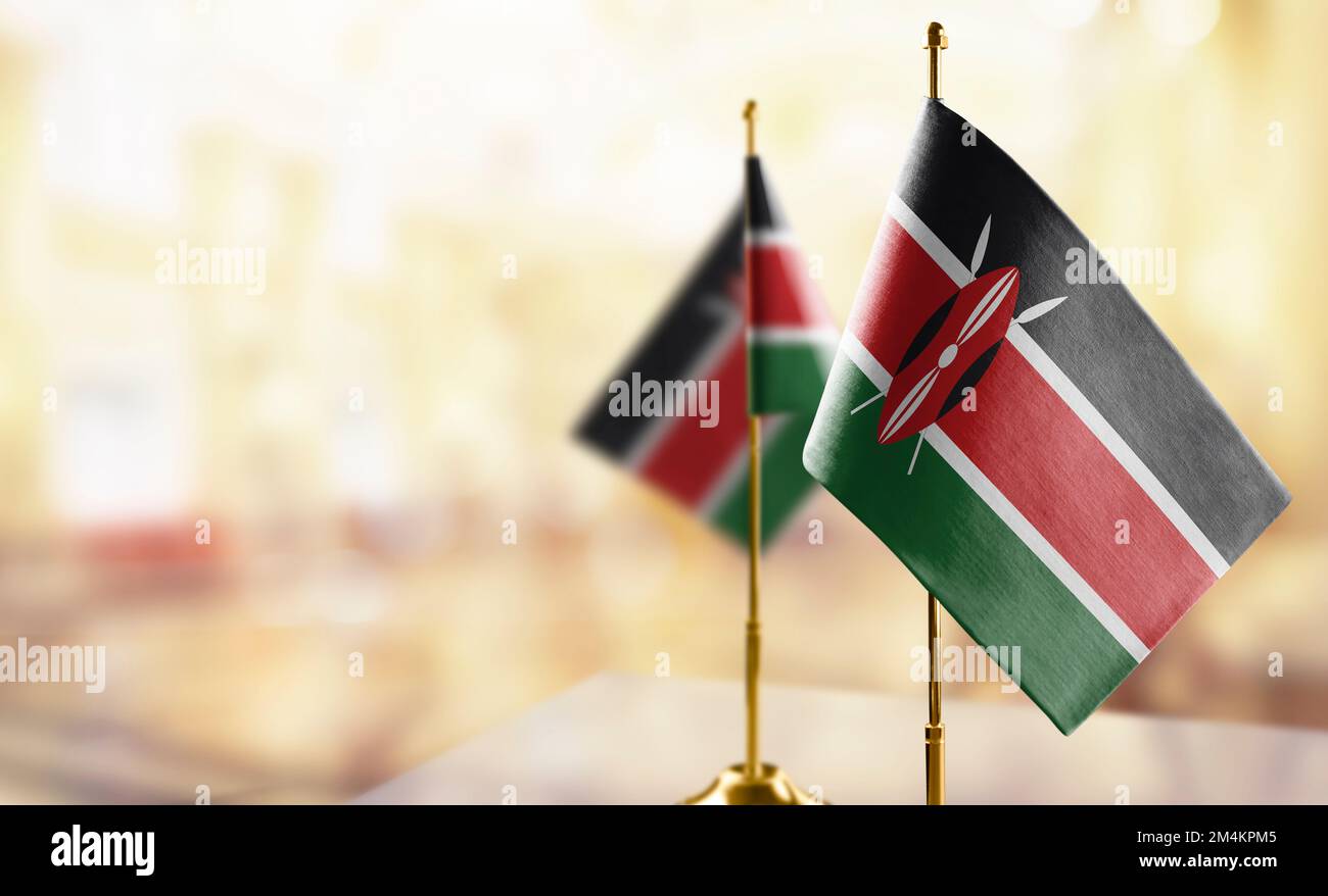Small flags of the Kenya on an abstract blurry background Stock Photo ...