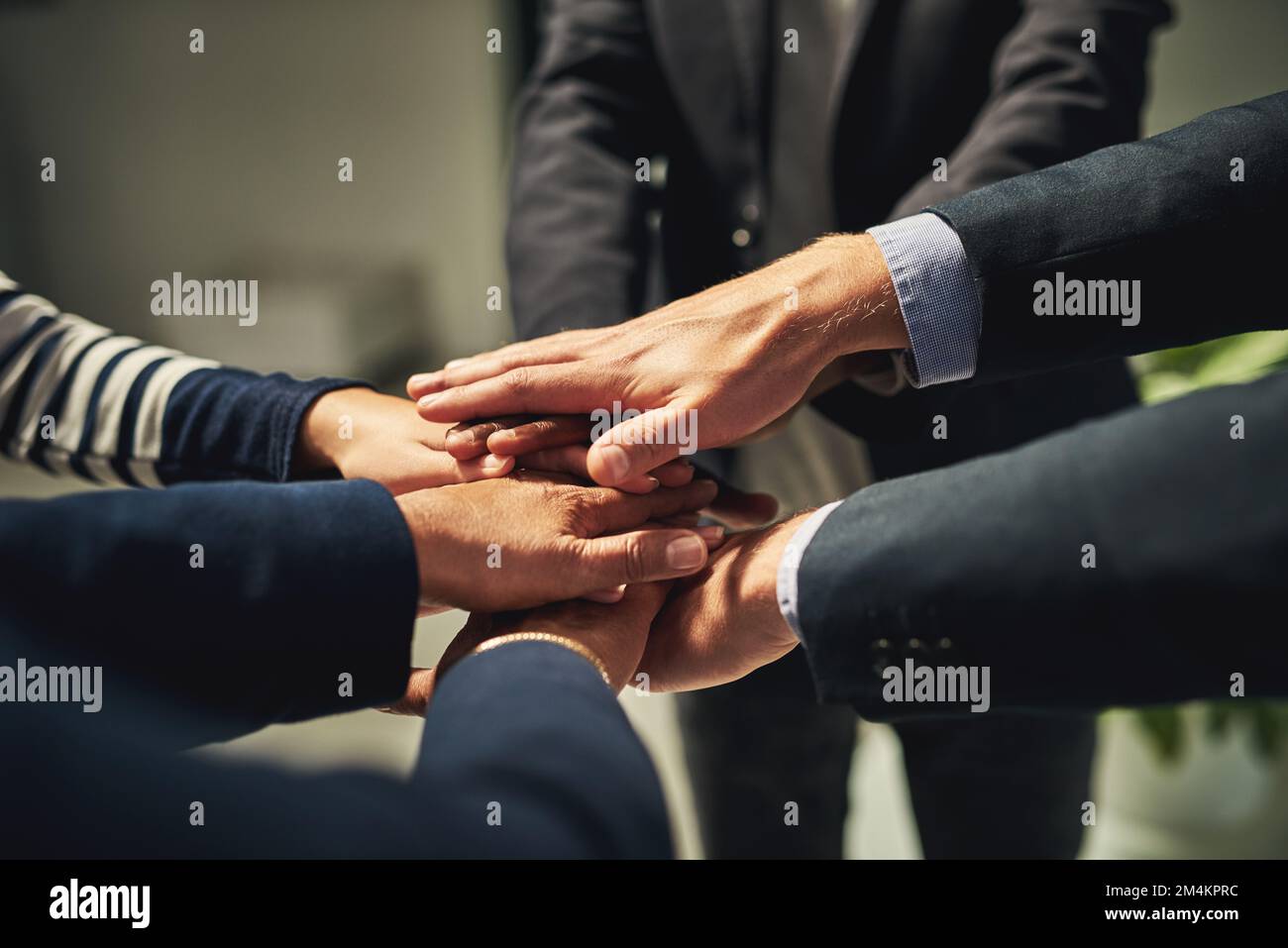 Lets pull together and make this happen. Closeup shot of a group of ...