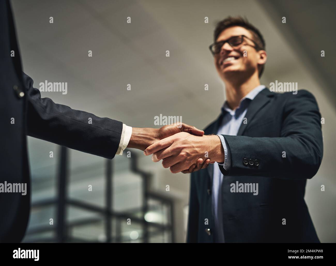 Lets make business better together. Low angle shot of two businessmen ...