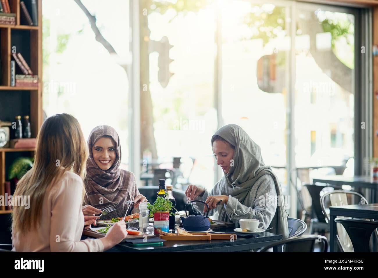 Brunch with the besties. a group of women getting together for lunch in ...