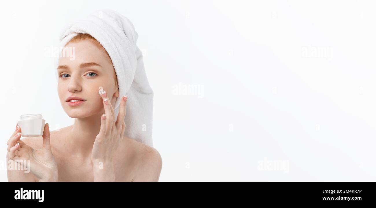 beautiful model applying cosmetic cream treatment on her face on white Stock Photo - Alamy