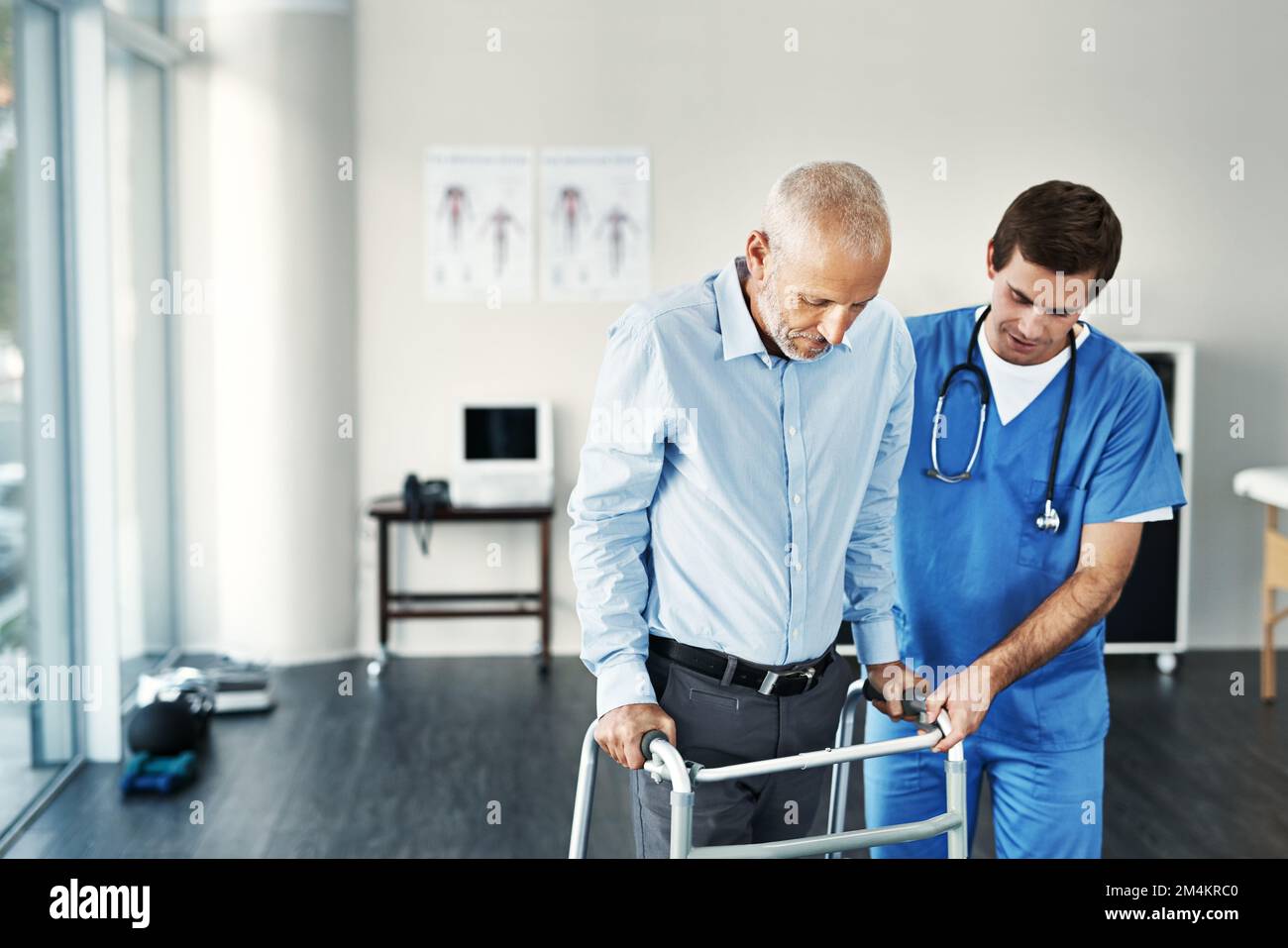 Each step will get easier. a male nurse assisting a senior patient with ...