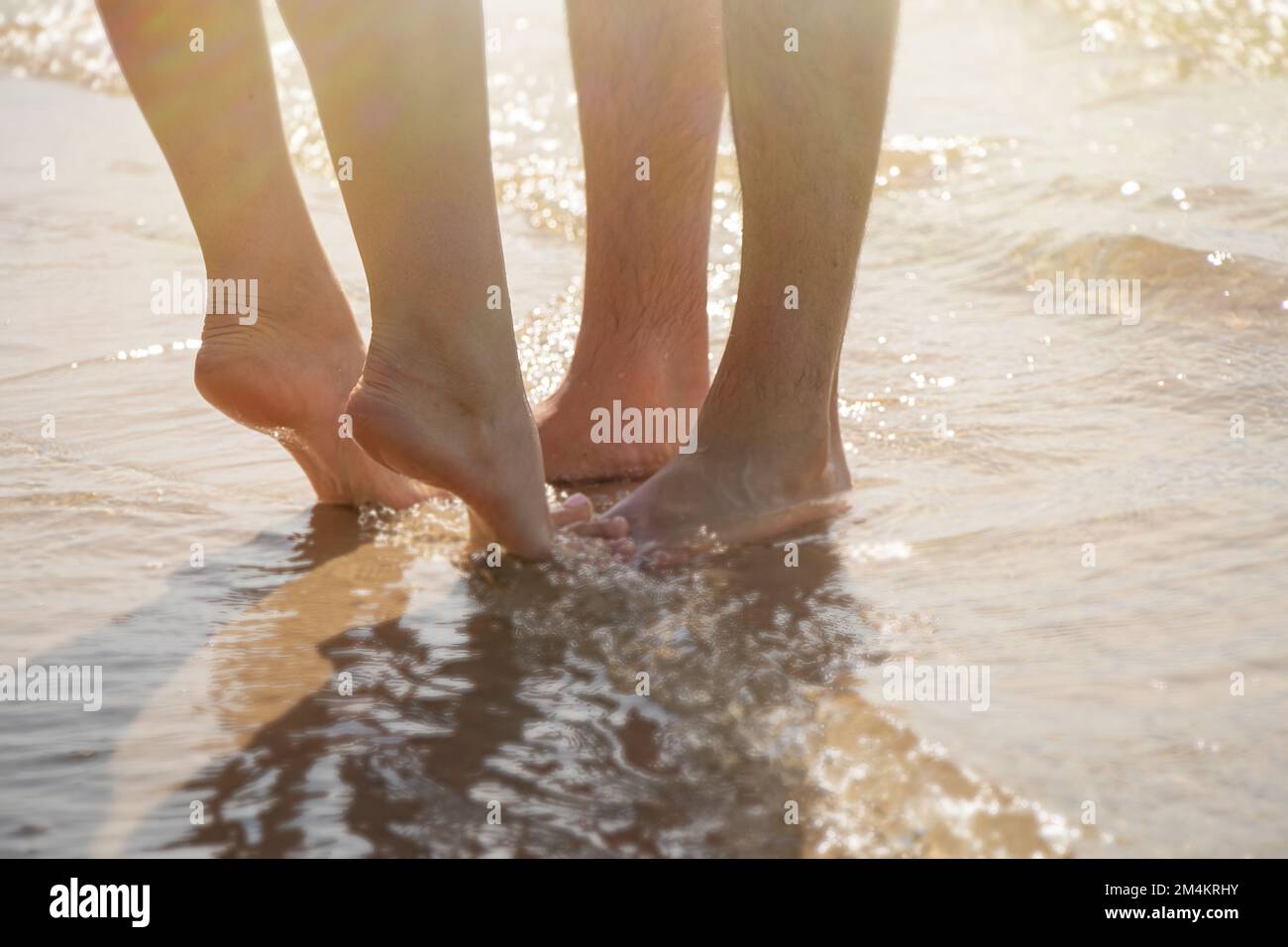 male and female feet in sea water bottom view in the sun Stock Photo ...