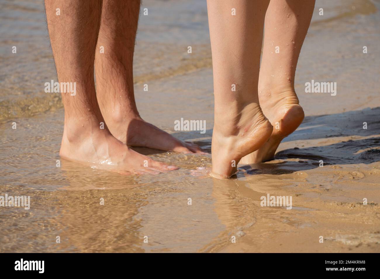 male and female feet in sea water bottom view in the sun Stock Photo ...