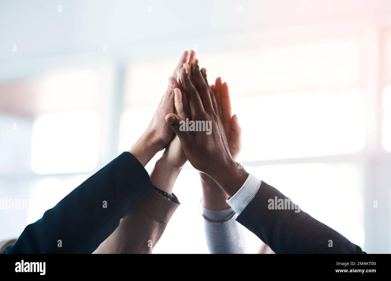 Teamwork gets the job done. group of unrecognizable businesspeople high ...