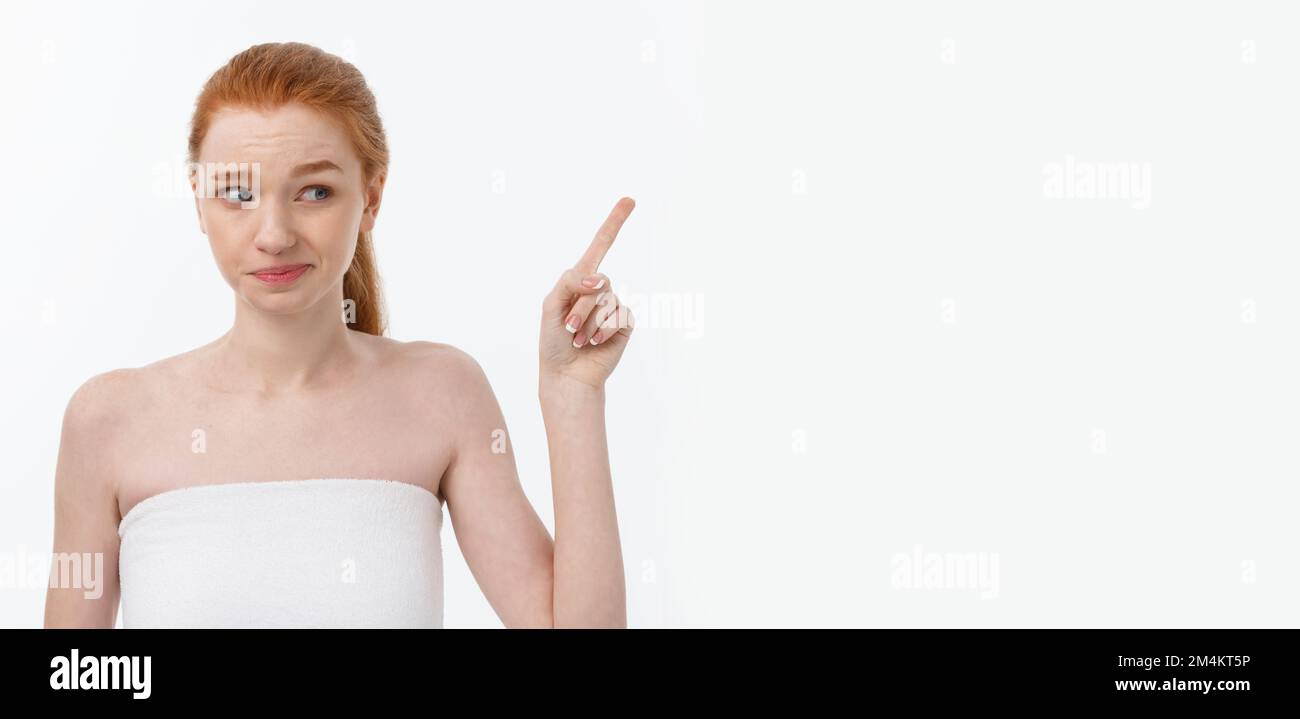 Portrait of caucasian cute in concern and shock, pointing index finger ...