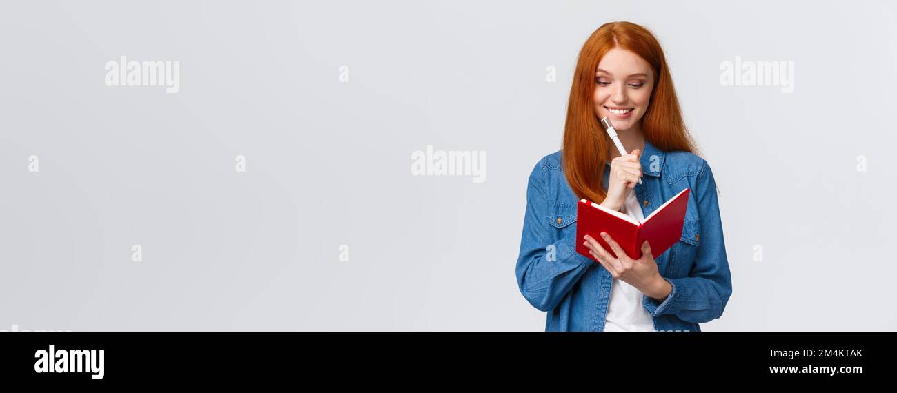 Creative smiling cute redhead woman, had romantic date, writing it down ...