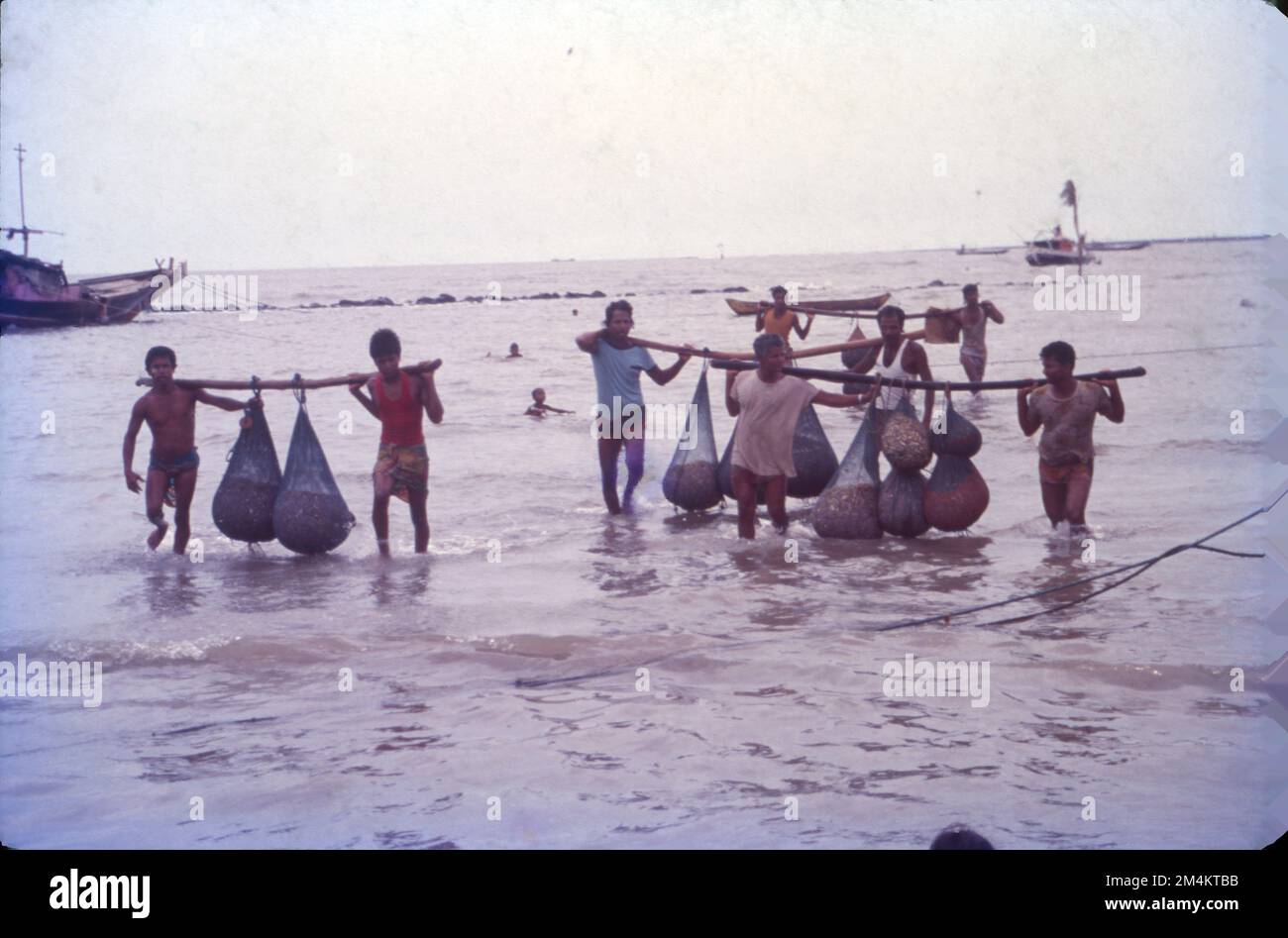 Fisherman holding fishes on sholders hi-res stock photography and ...