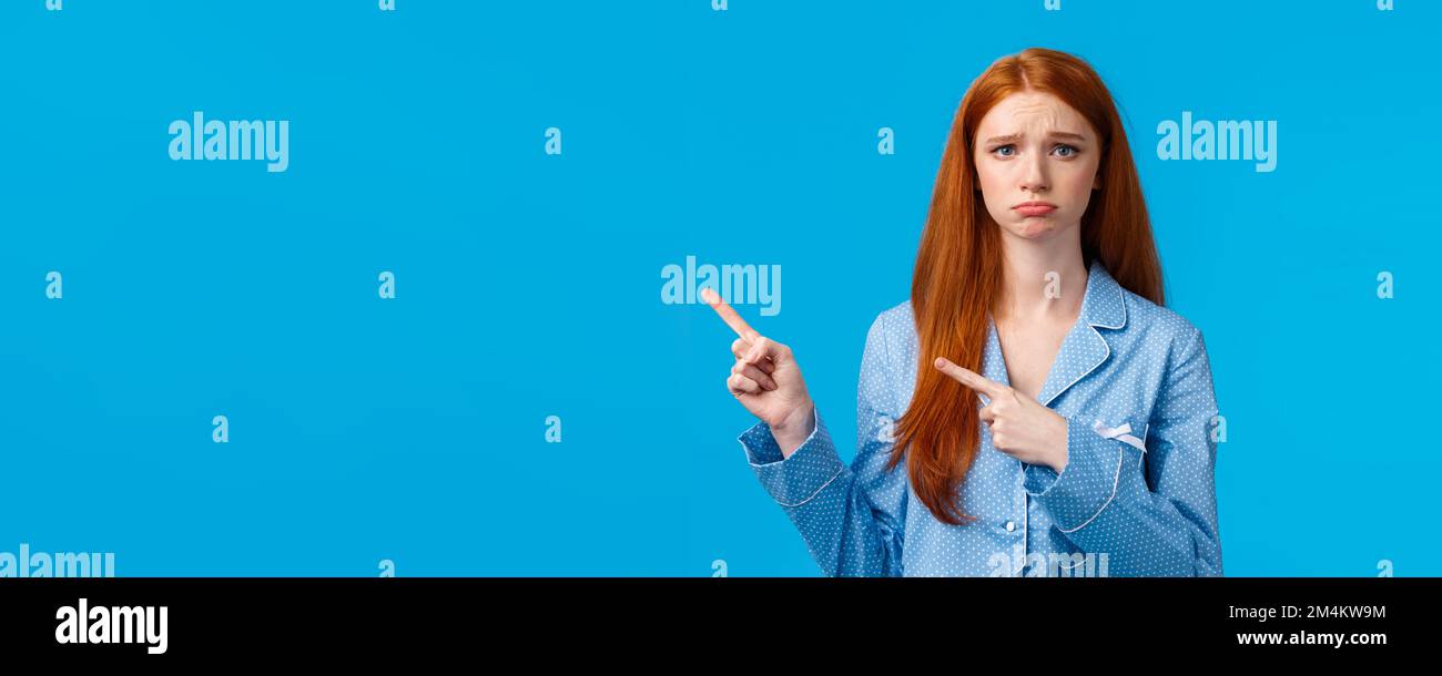 Sad sulking cute teenage girl with red hair asking parents something on ...
