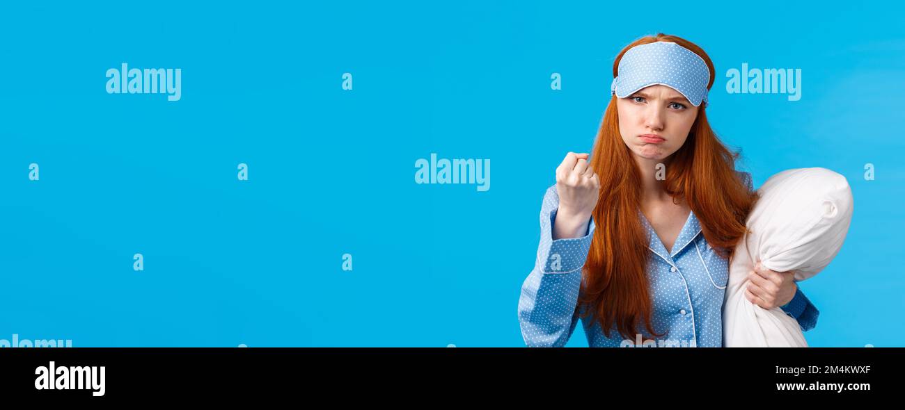 Who disturbed my sleep. Mad and displeased, angry grumpy redhead woman ...