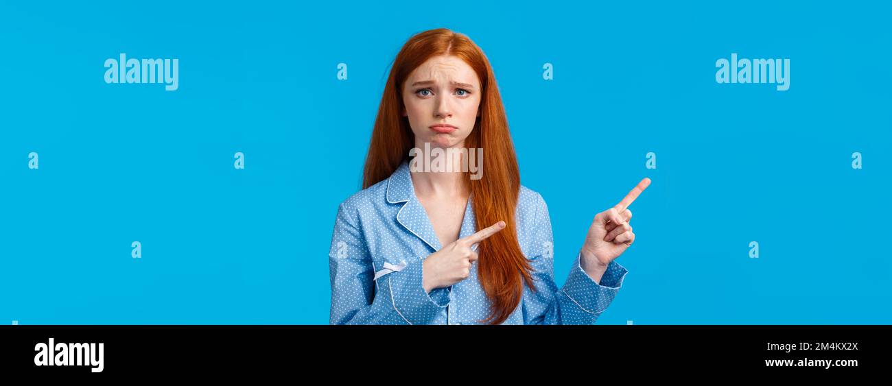 Sad sulking cute teenage girl with red hair asking parents something on ...