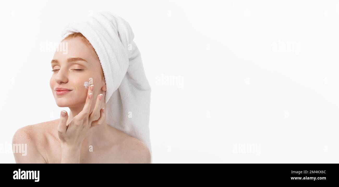 beautiful model applying cosmetic cream treatment on her face on white Stock Photo - Alamy