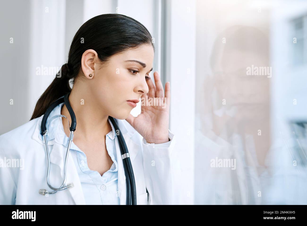 Saving lives is a tough job. a young female doctor looking stressed out ...