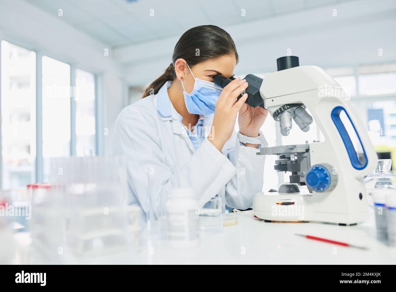 Making sense of the sample. a young scientist using a microscope in a ...