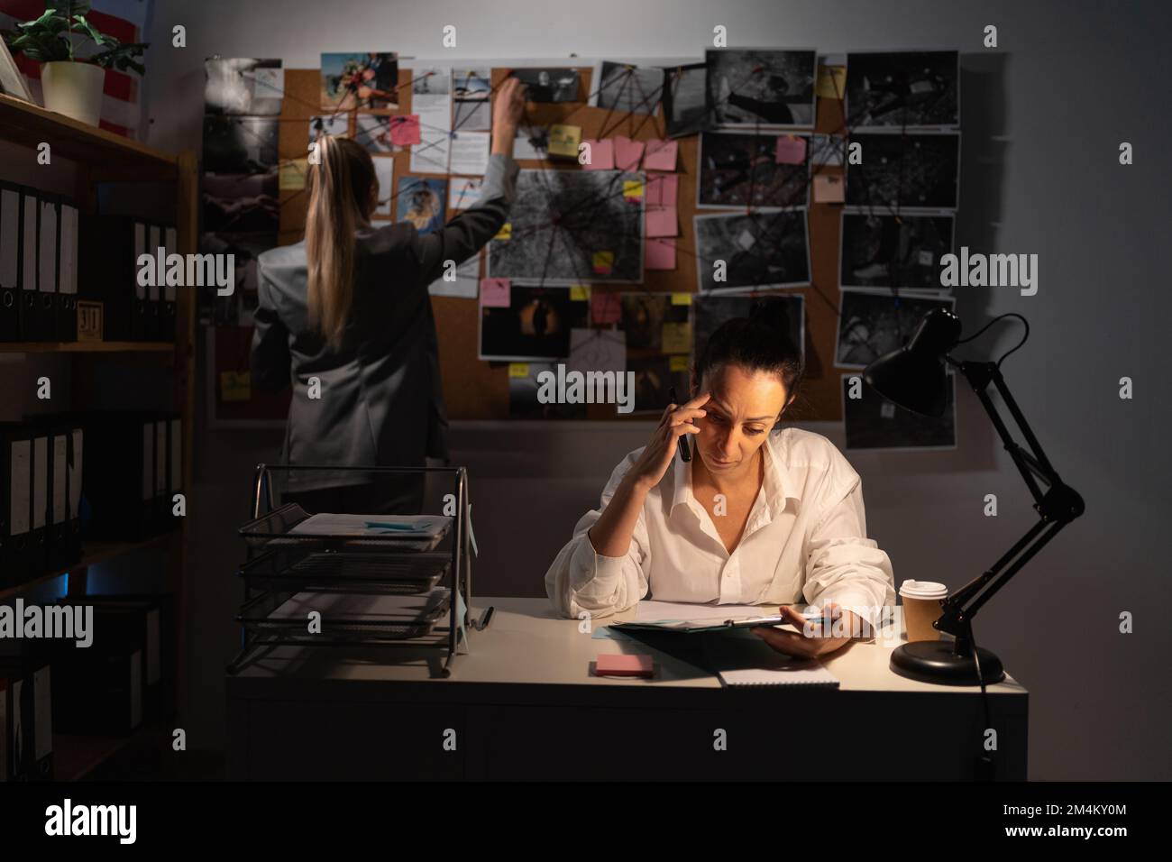 Colleagues detectives working in the office investigating a crime ...