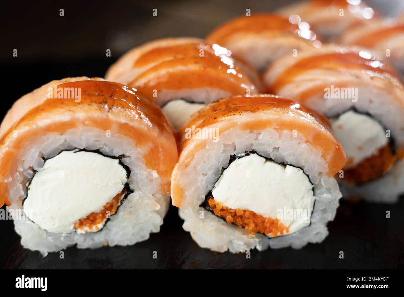 Traditional delicious sushi roll set on a black background with ...