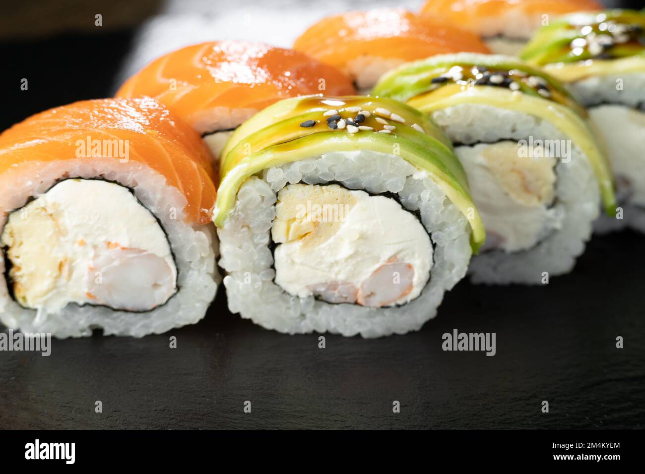 Close up of Rainbow Sushi Roll with salmon, avocado, royal prawn, cream ...