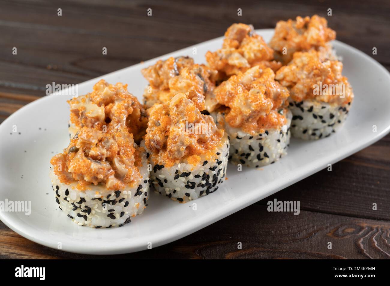 Japanese sushi volcano roll with eel on top and sesame inside, side ...