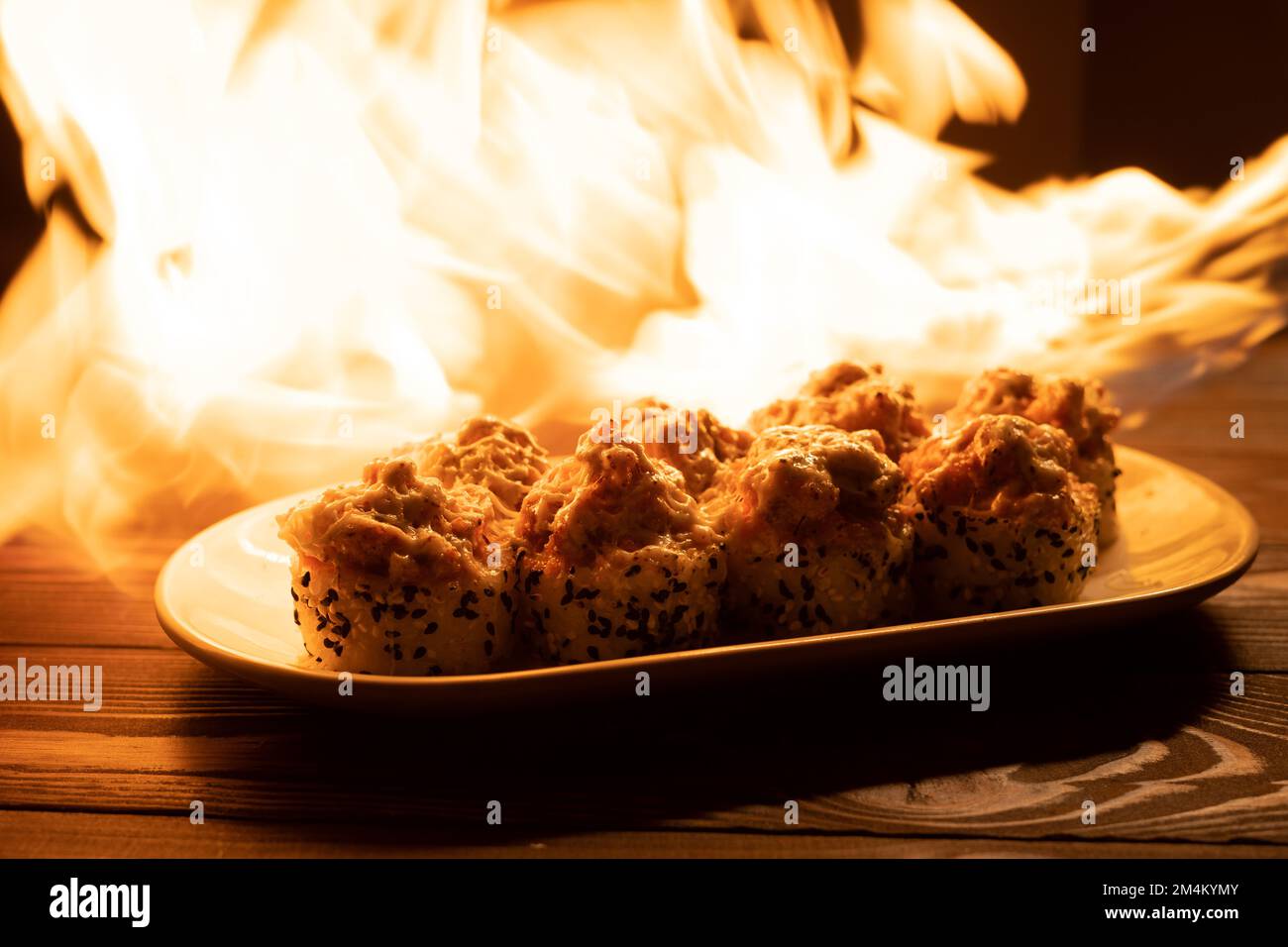 Burning torch over sushi cooking Japanese food. Japanese cuisine ...