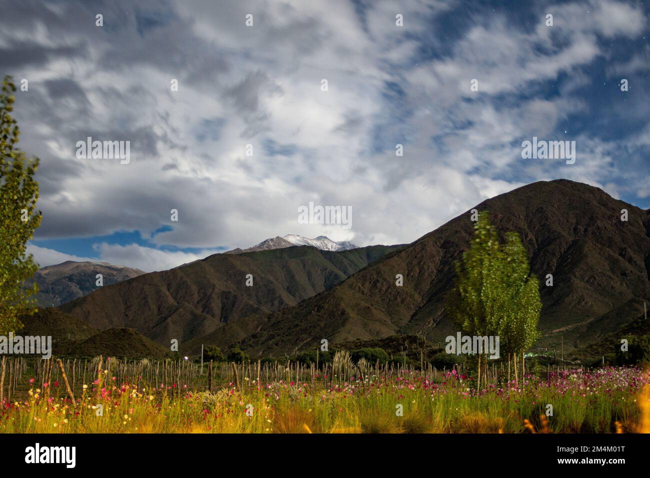 A beautiful valley with mountains and a cloudy blue sky in the ...